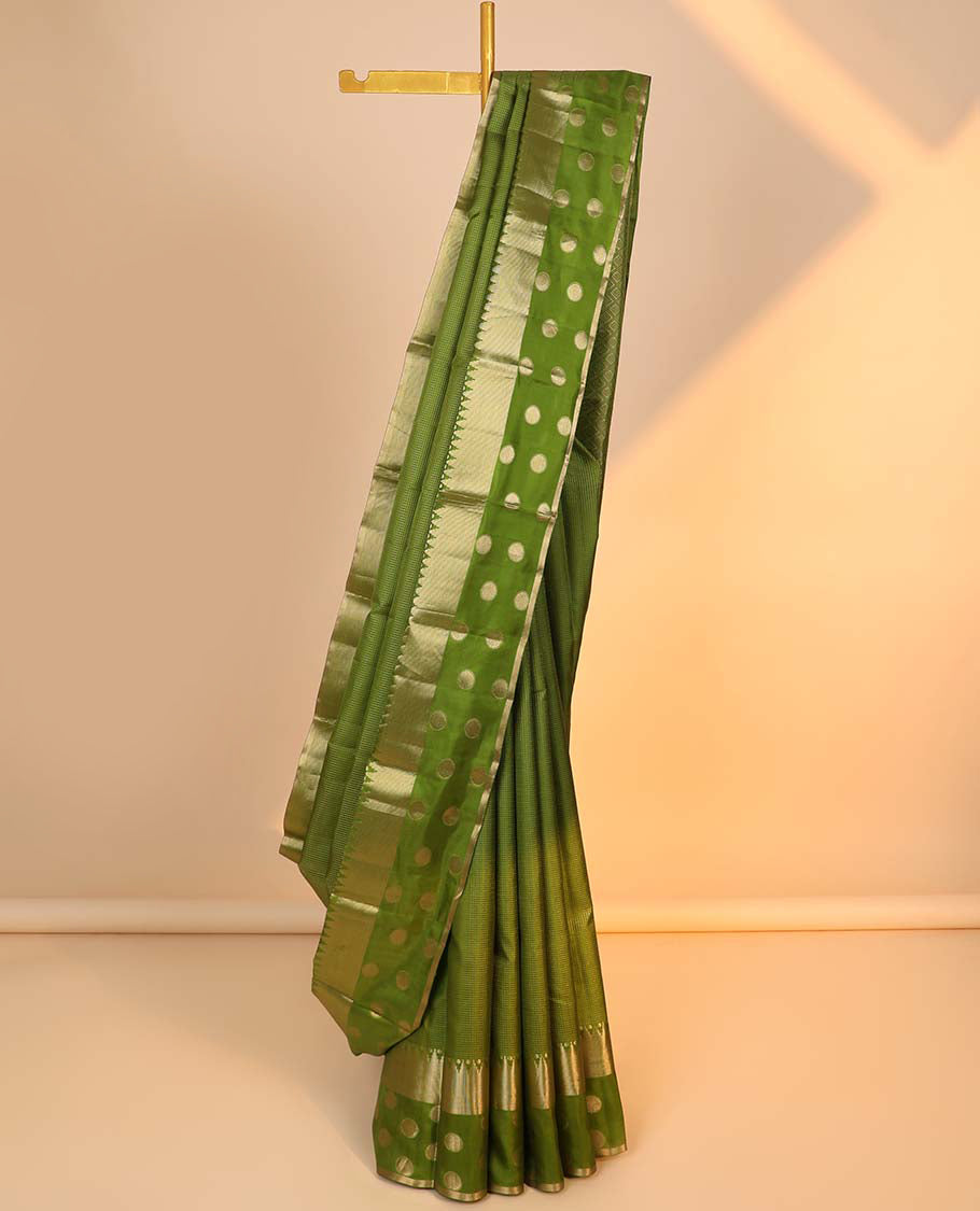 Green checked design silk saree, zari temple border of poo chakram des