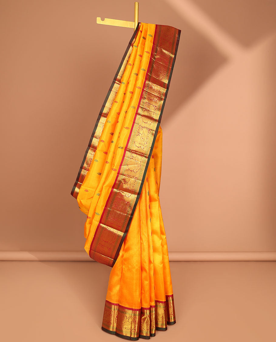 Orange floral buttas kancheepuram silk saree with contrast korvai intr